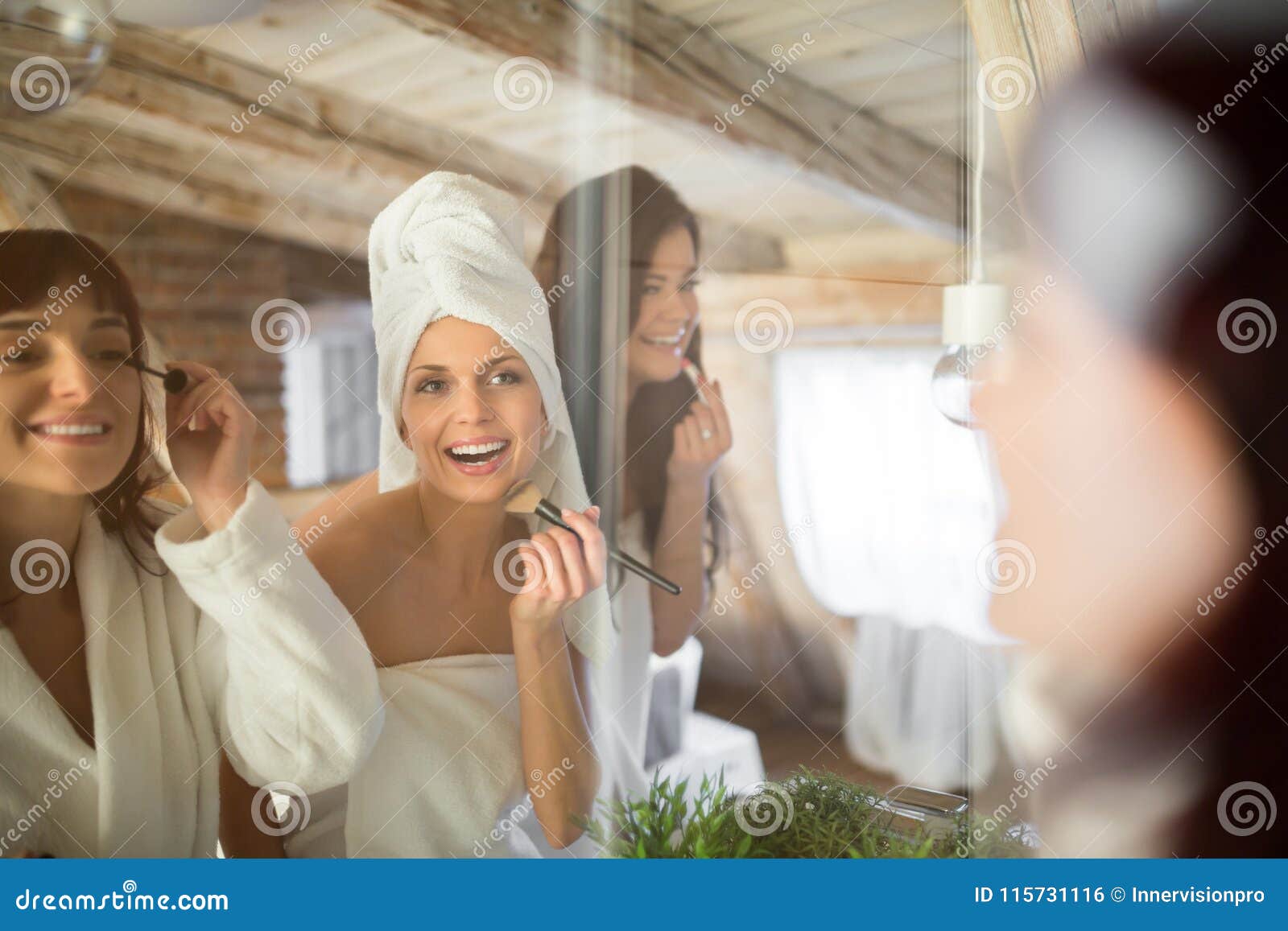 Three Happy Women Reflecting in Mirror Doing Make Up Stock Photo ...