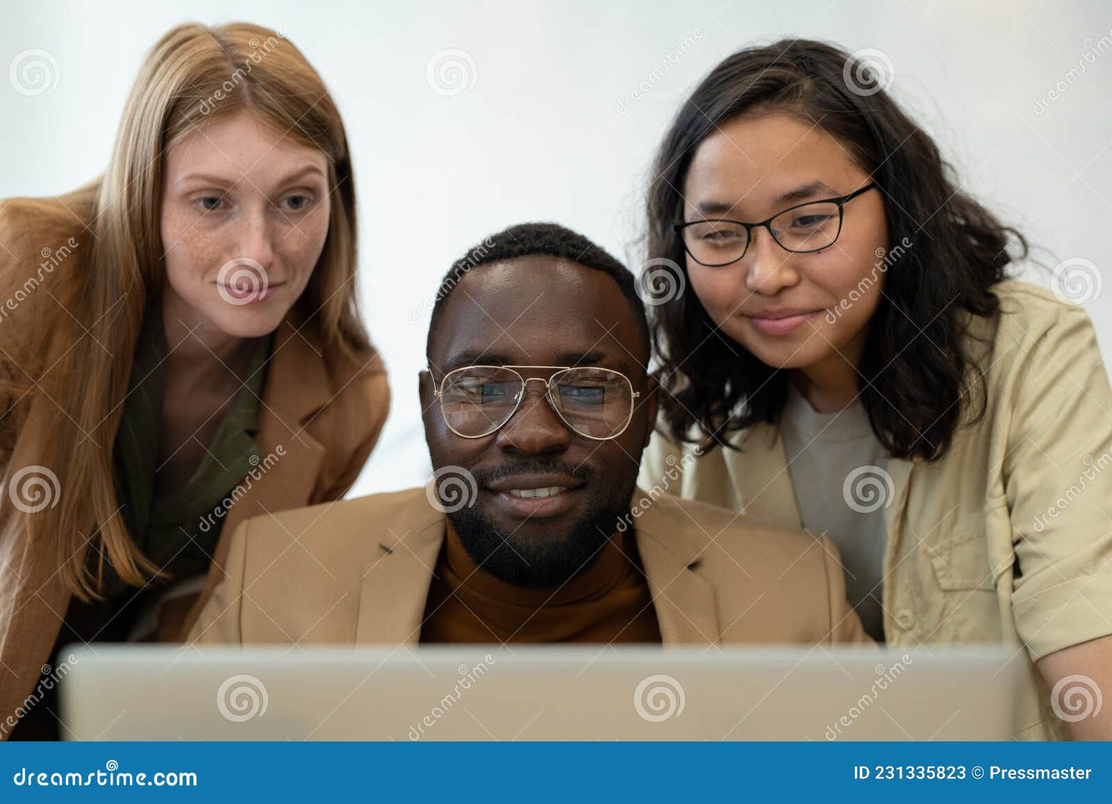 Three Happy Young Employees Looking at Screen of Laptop Stock Image ...
