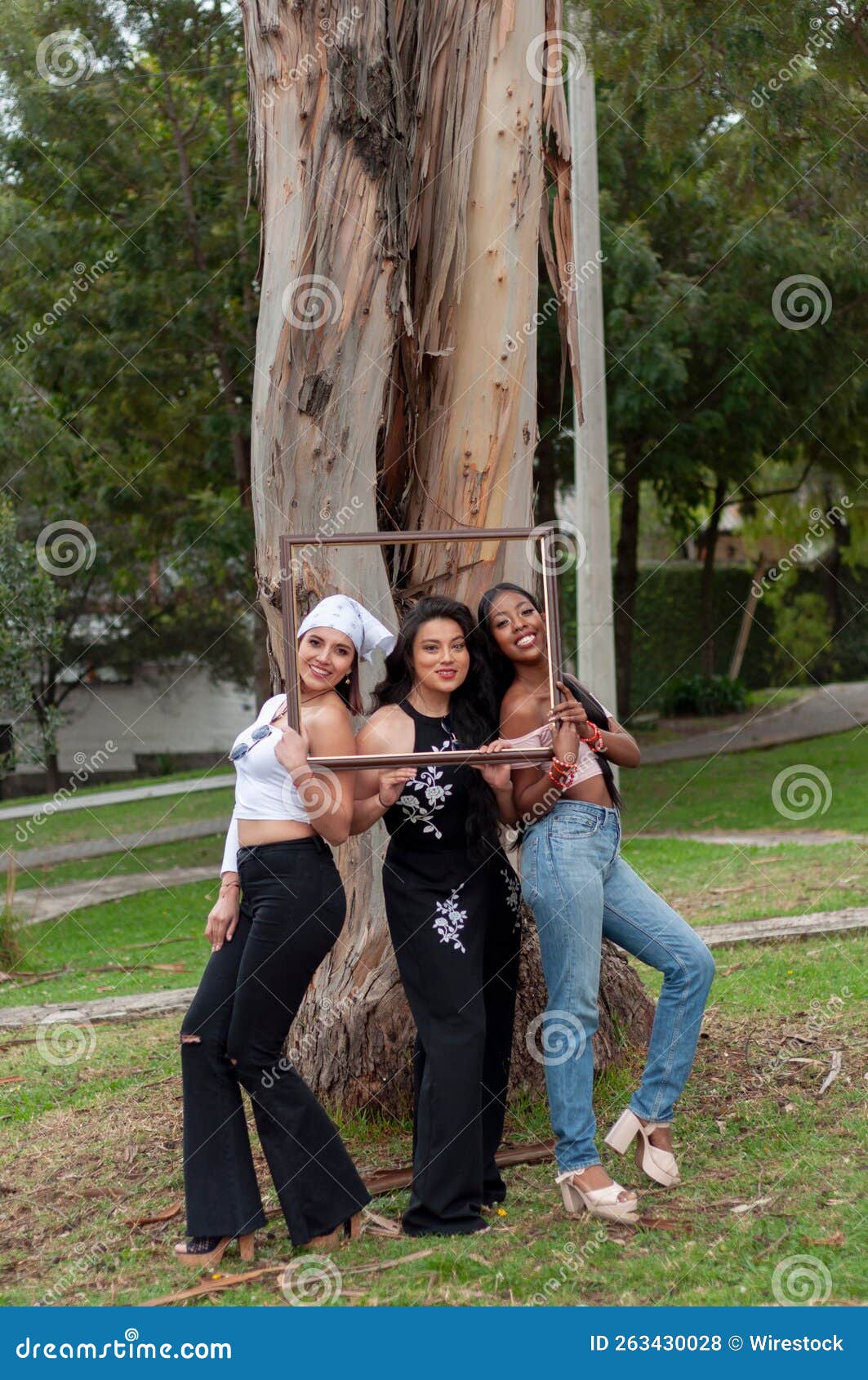Three Happy Young Friends Posing with Photo Frame Stock Photo - Image ...