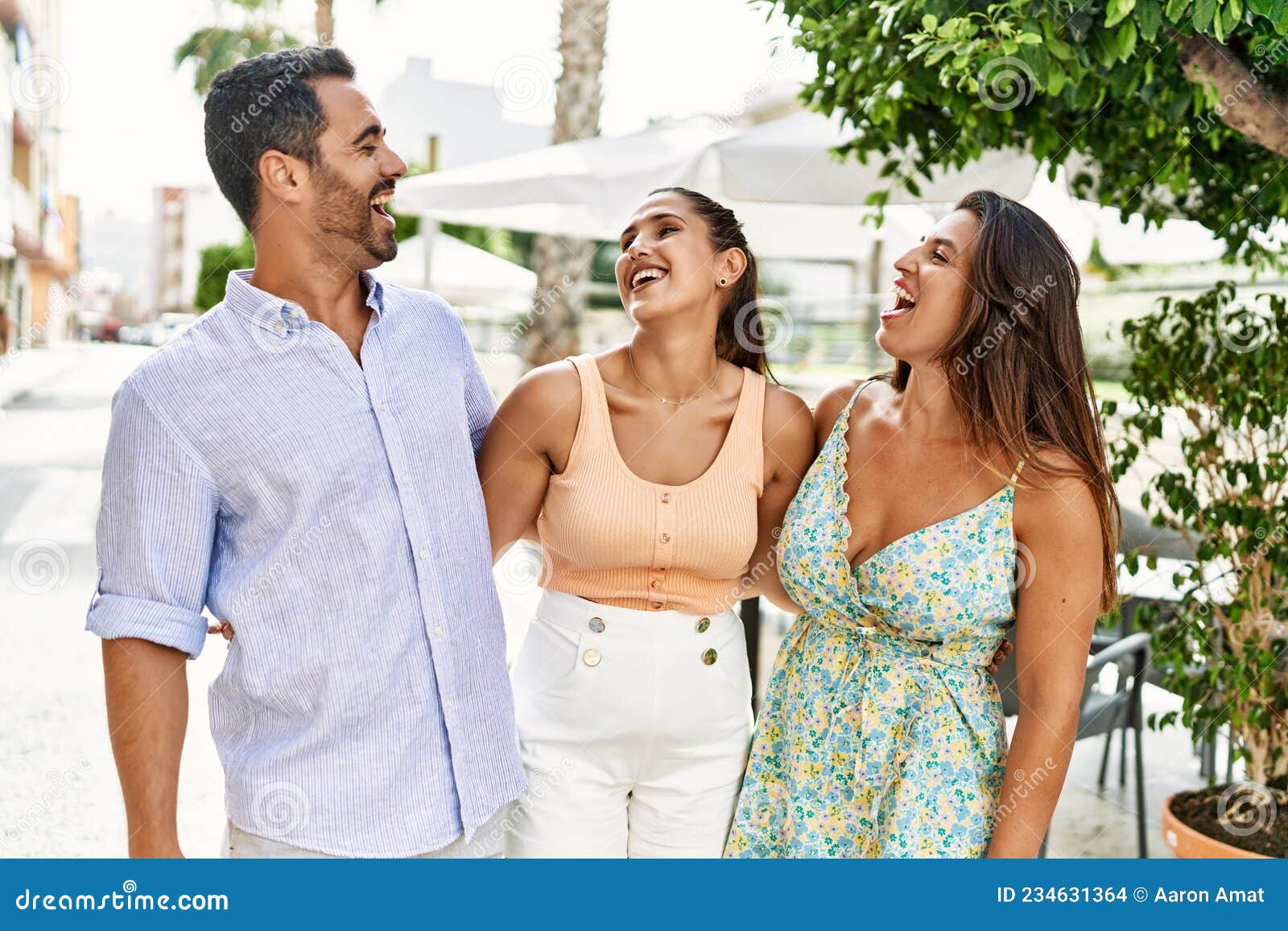 Three Hispanic Friends Smiling Happy and Hugging at the City Stock ...