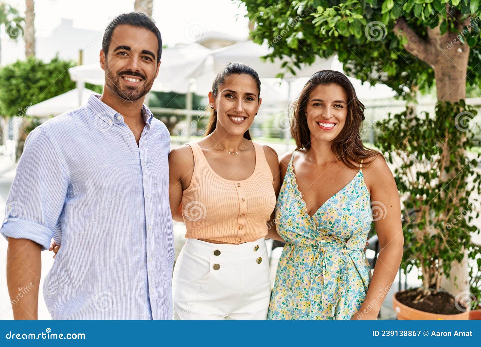 Three Hispanic Friends Smiling Happy and Hugging at the City Stock ...