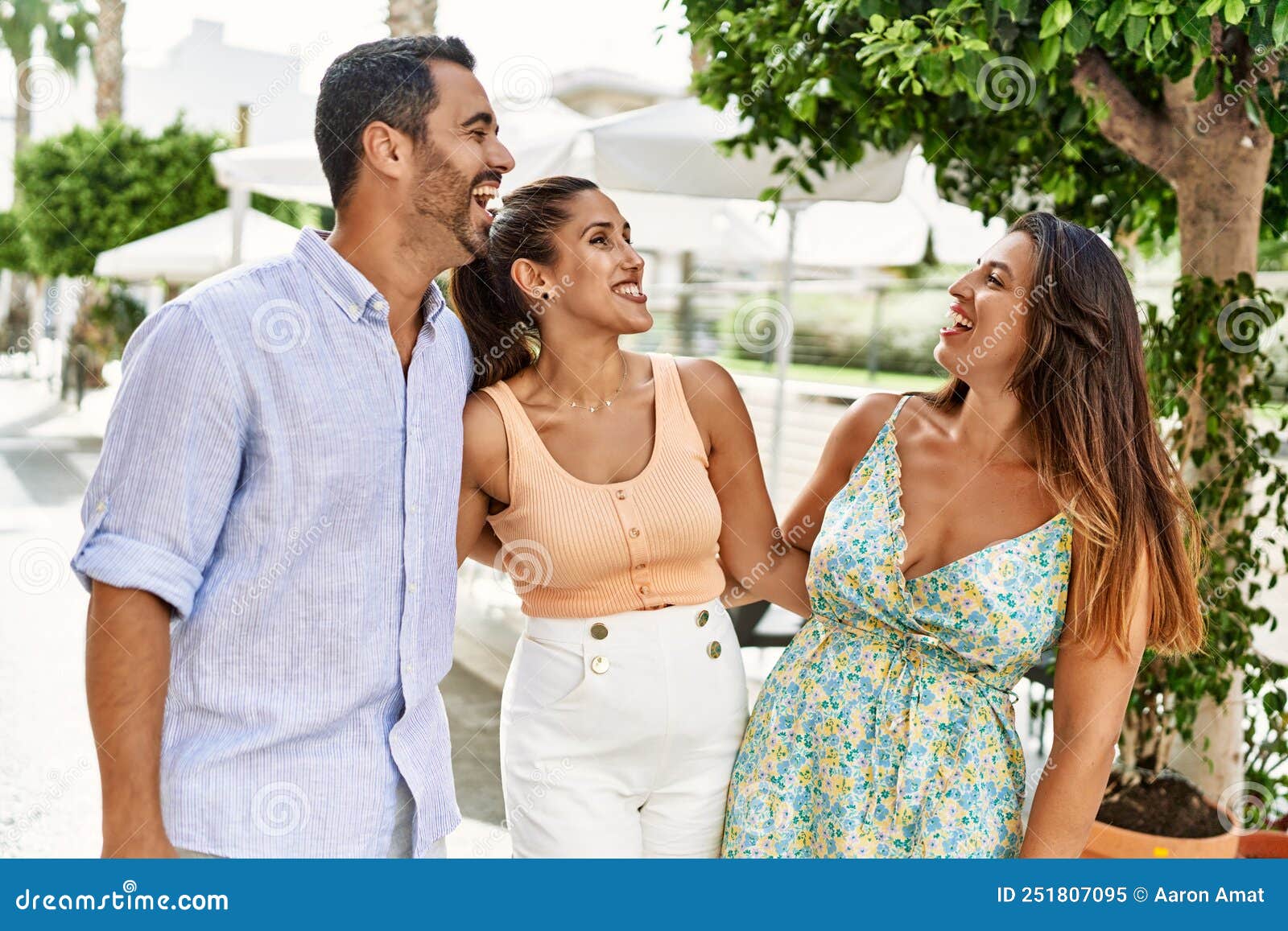 Three Hispanic Friends Smiling Happy and Hugging at the City Stock ...