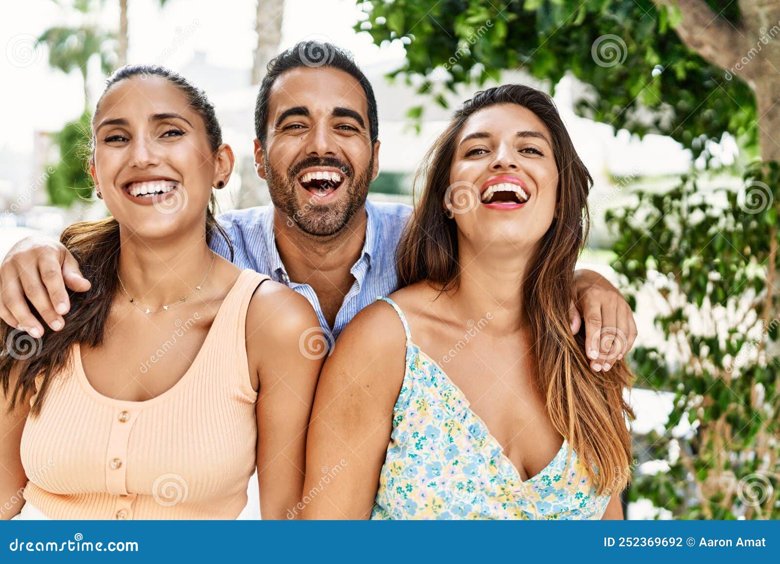 Three Hispanic Friends Smiling Happy and Hugging at the City Stock ...