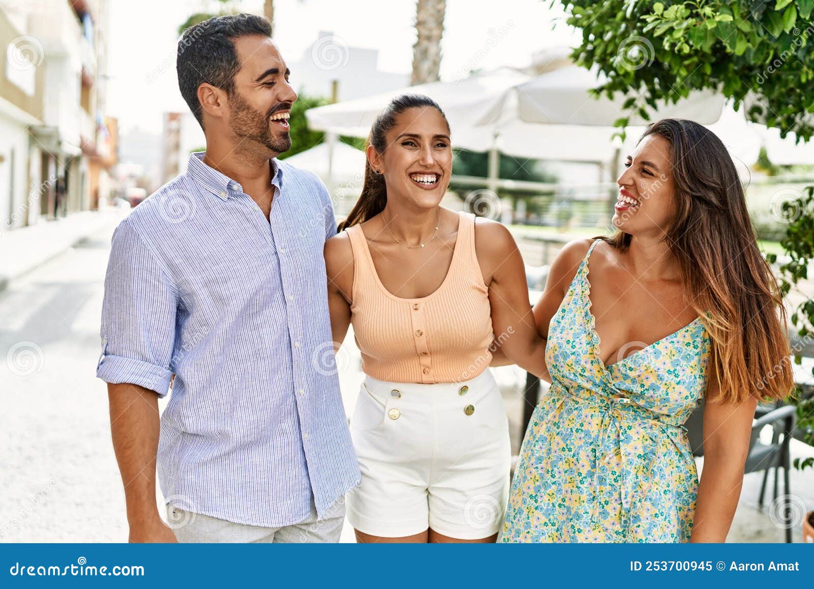 Three Hispanic Friends Smiling Happy and Hugging at the City Stock ...