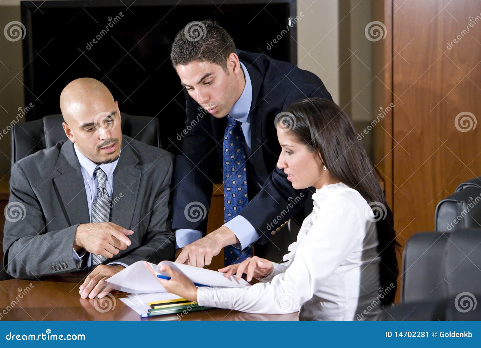 Three Hispanic Office Workers Reviewing Report Stock Image - Image of ...