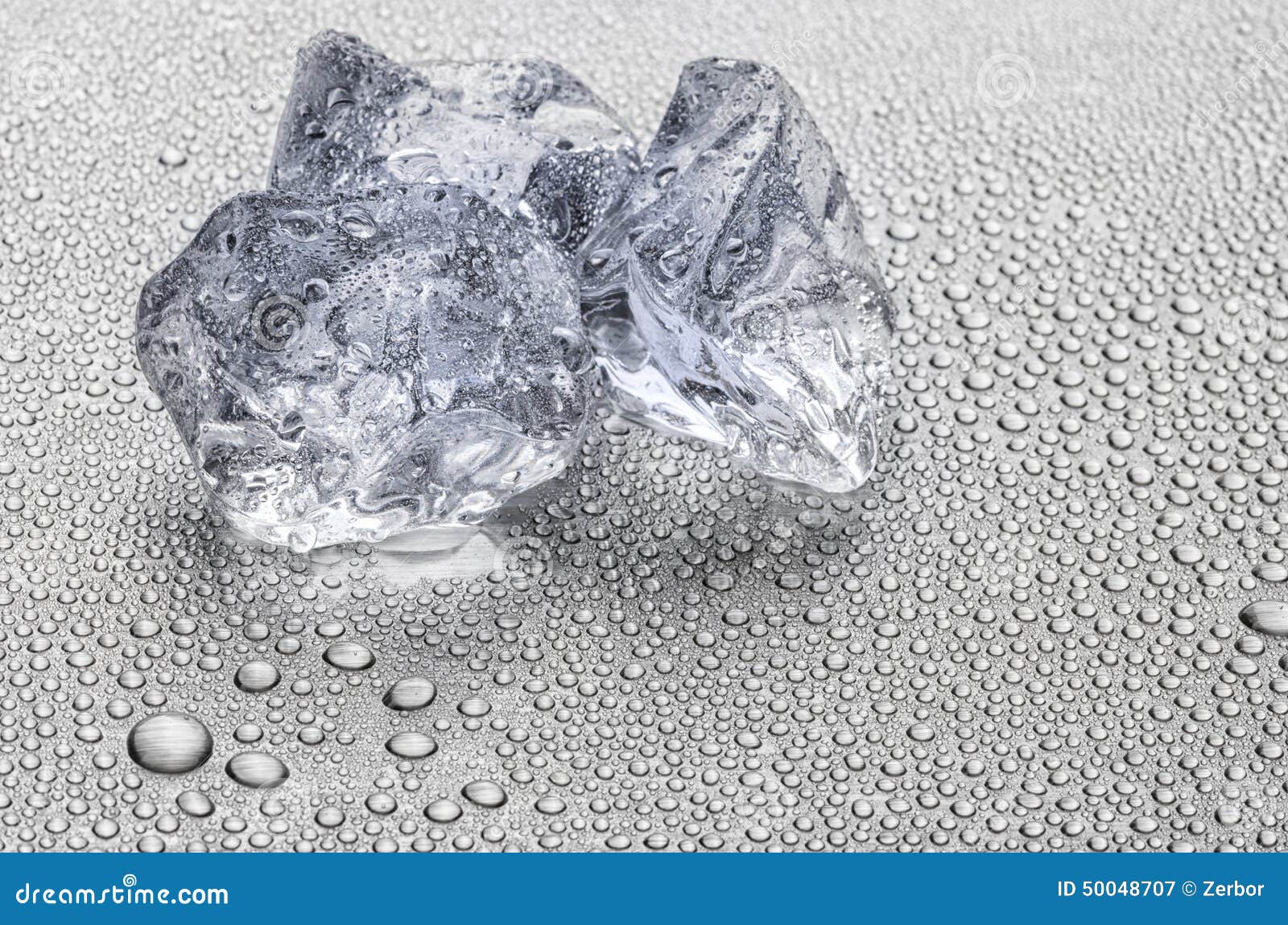 Three Ice Cubes on a Metallic Surface with Water Drops Stock Image ...