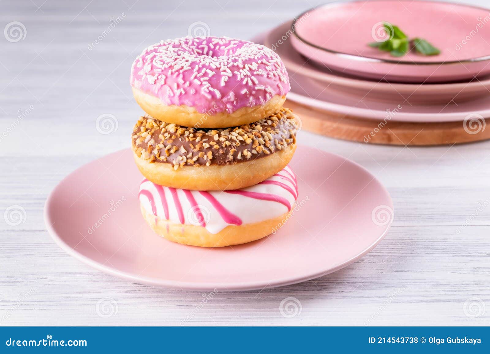 Three Iced Donuts are Stacked on a Pink Ceramic Plate Stock Photo ...