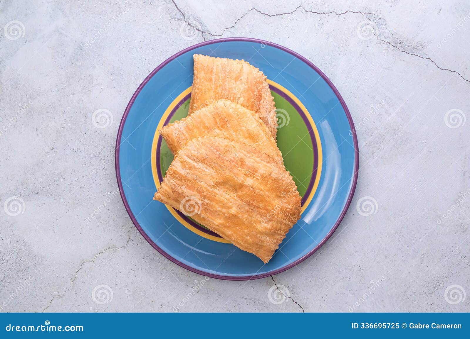 Three Jamaican Beef Patties on a Large Colourful Plate Stock Image ...