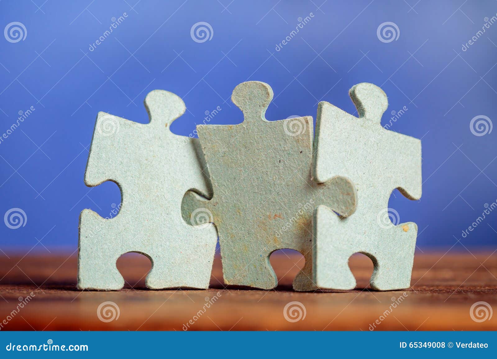 Three Jigsaw Puzzle Pieces on a Table Stock Photo - Image of bonding ...