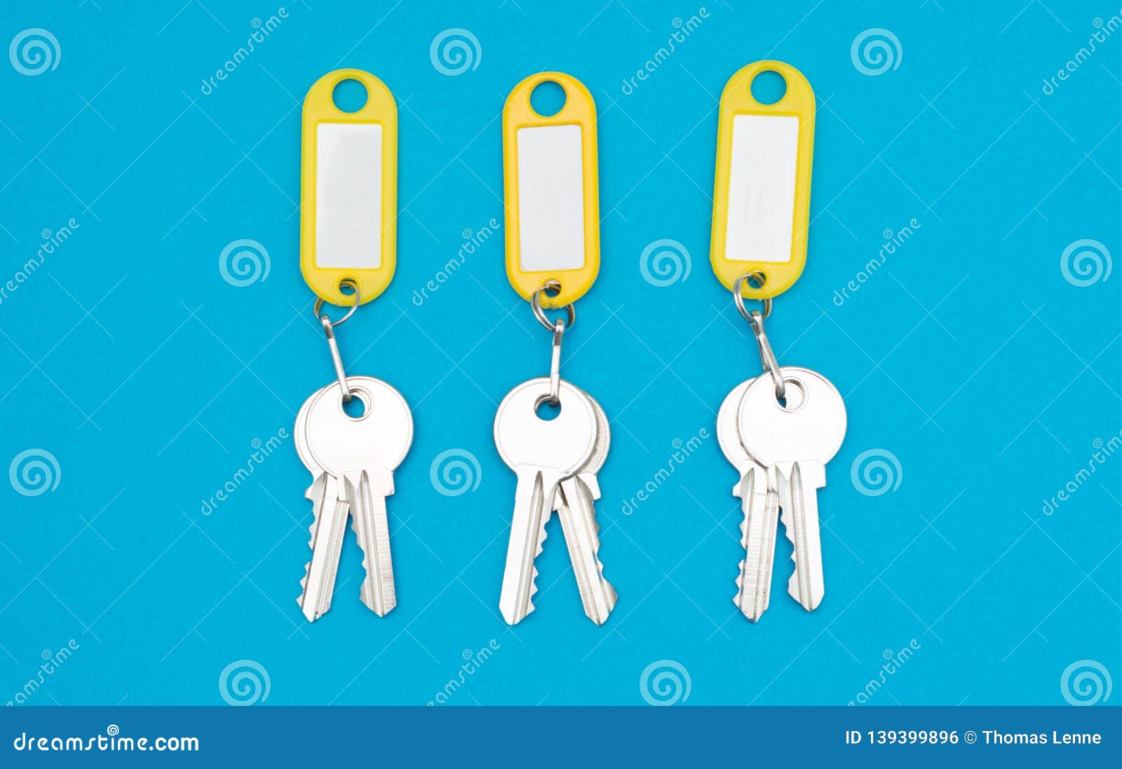 Three Keys Pair on Yellow Keychains Blue Background Stock Photo - Image ...