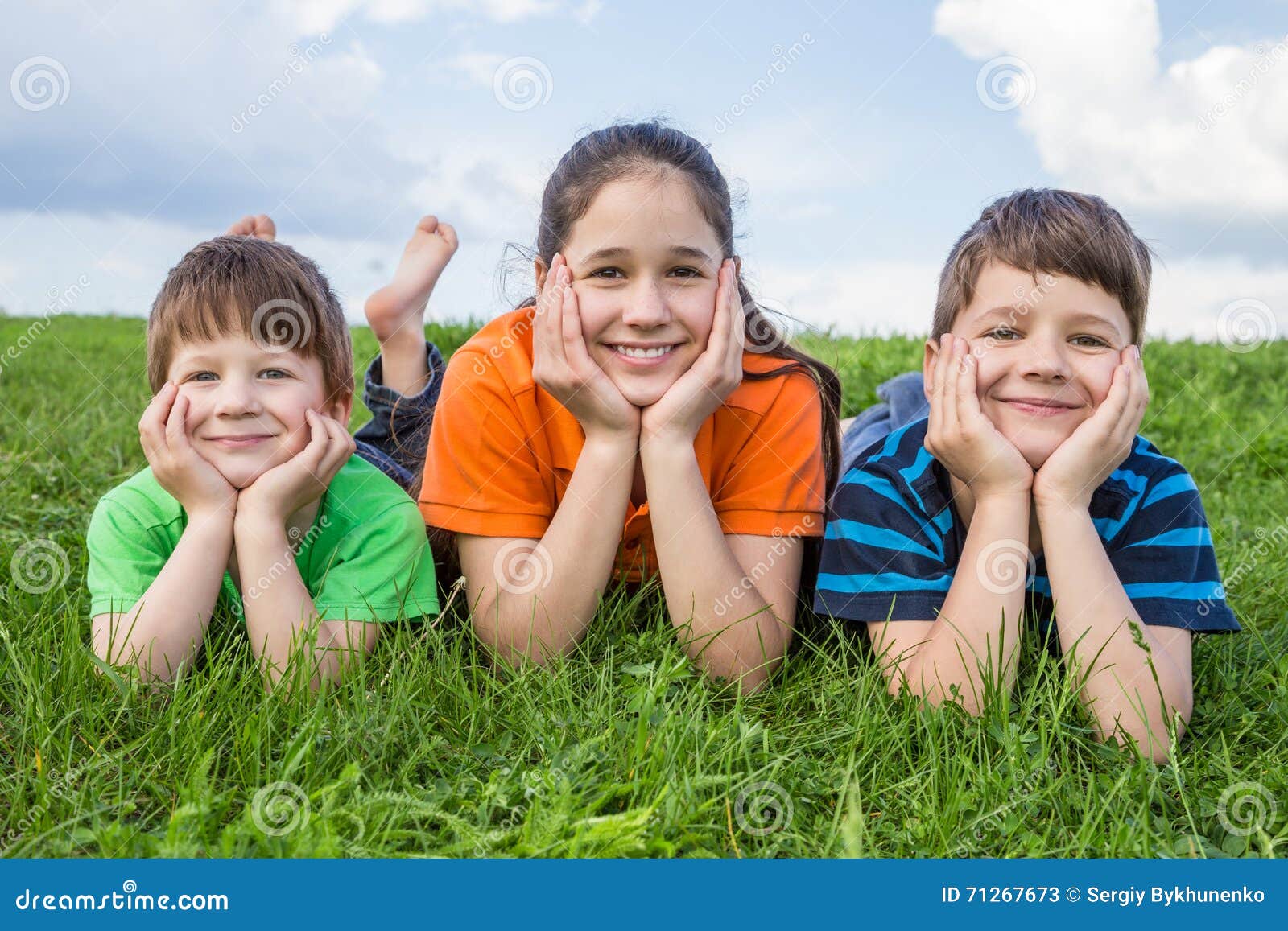 Three kids on green meadow stock image. Image of friendship - 71267673