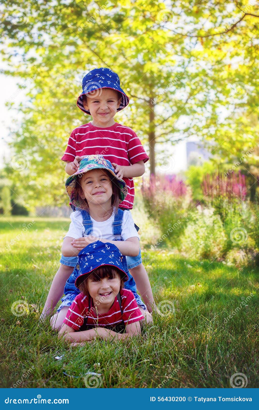 Three Kids in the Park, Standing One Over the Other, Smiling Stock ...
