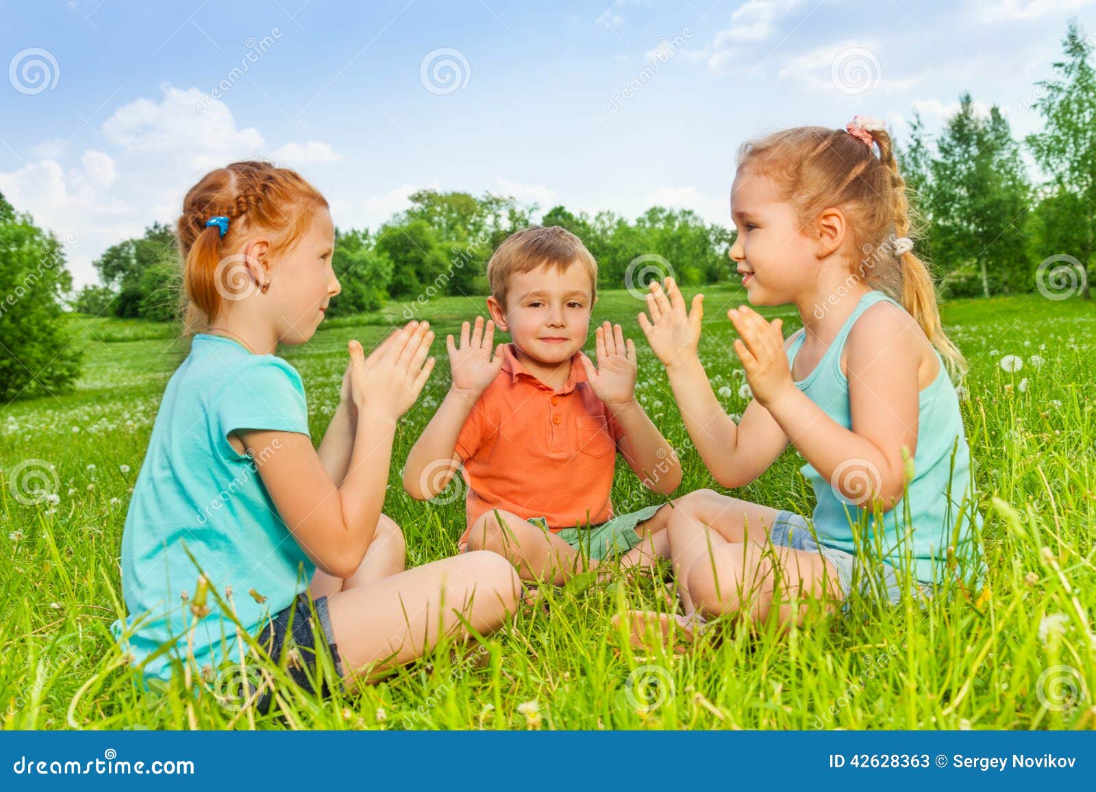 Three Kids Playing on a Grass Stock Image - Image of kids, look: 42628363