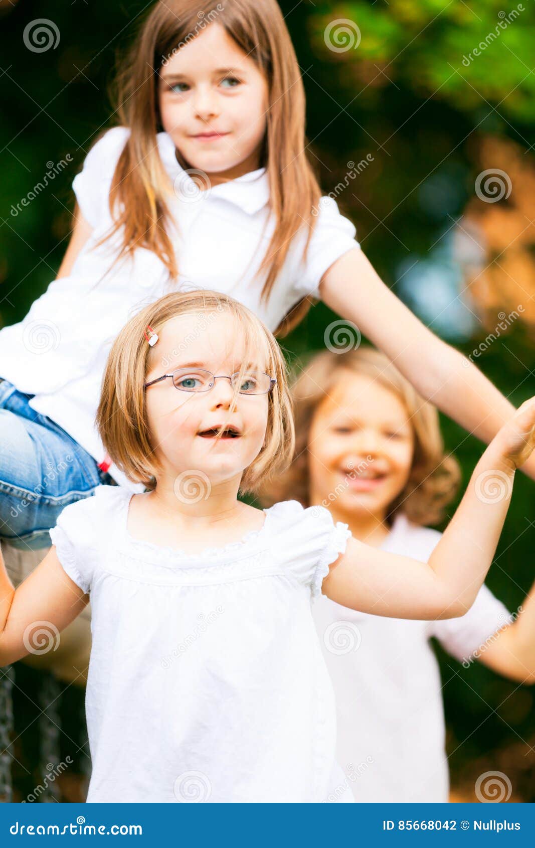 Three Kids Playing Outside stock photo. Image of friends - 85668042