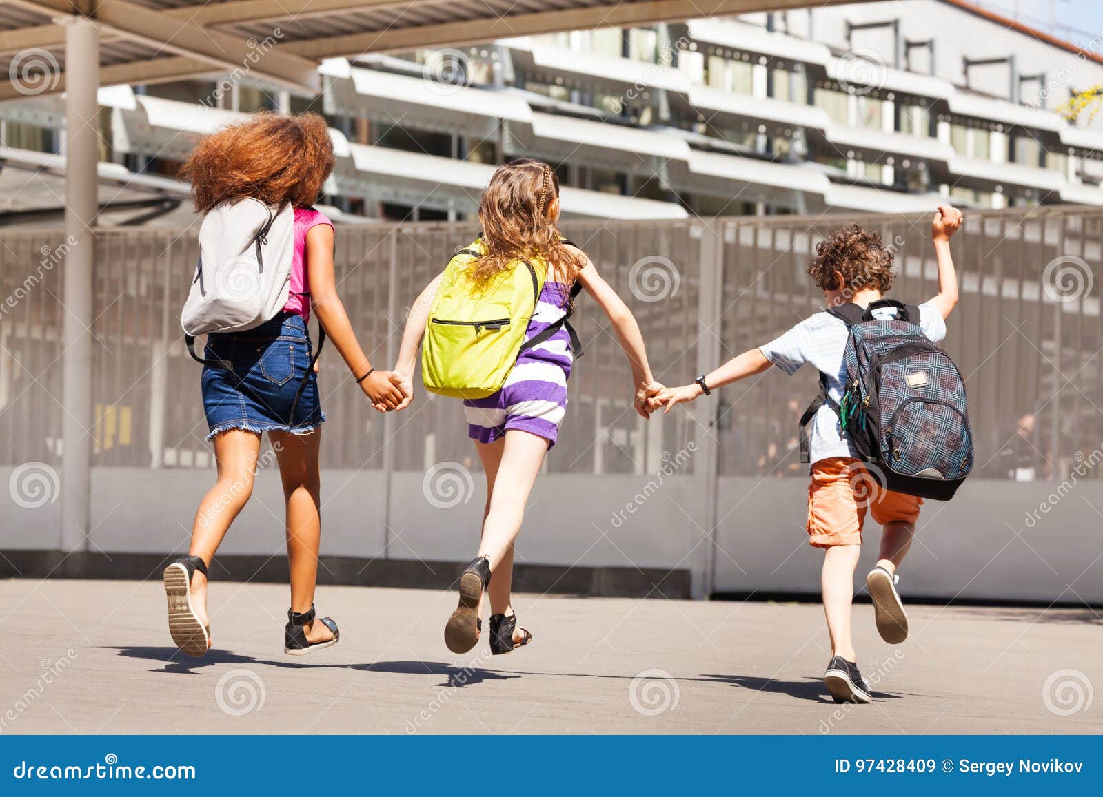 Three Kids Run To School View from Behind Stock Image - Image of ...