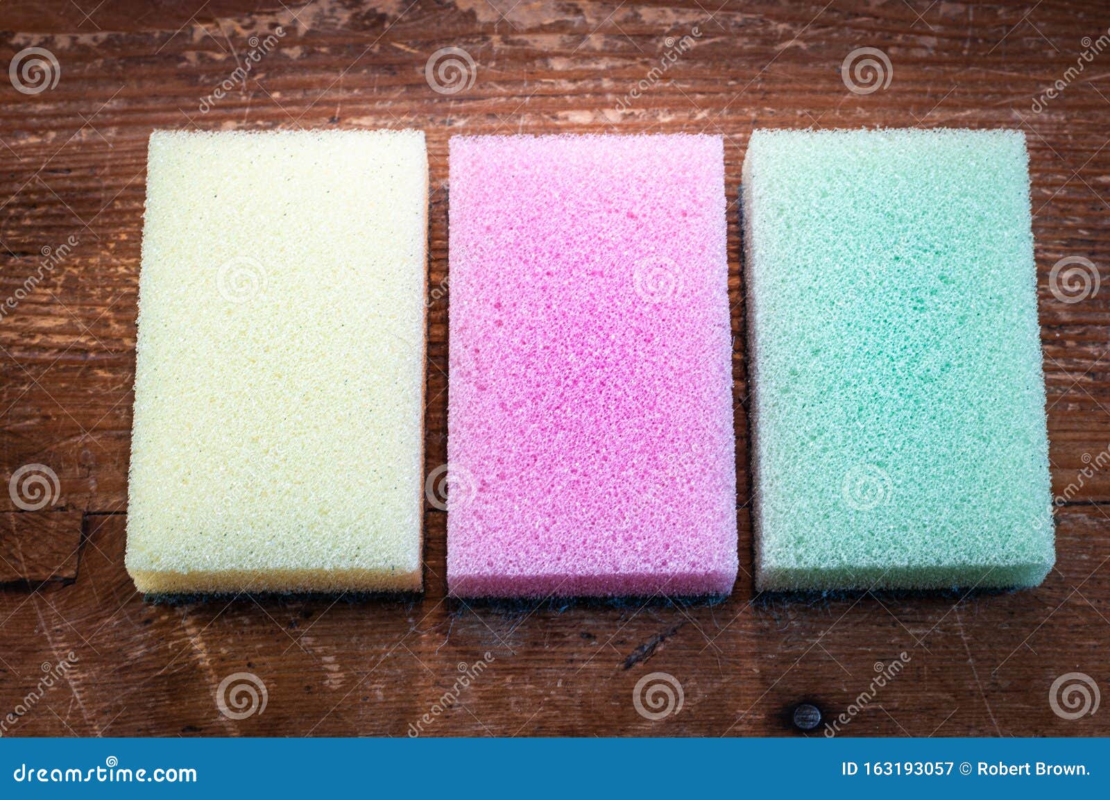 Three Kitchen Sponges on a Wooden Table Stock Image - Image of ...