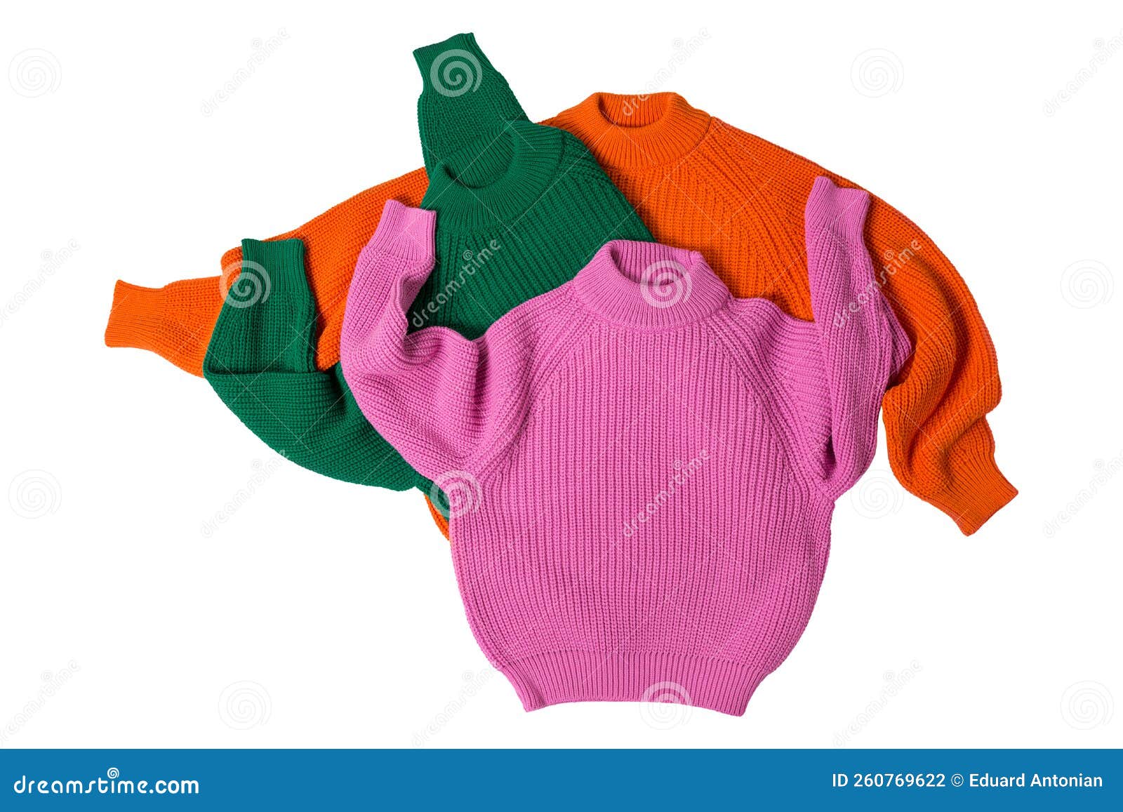 Three Knitted Sweaters of Different Colors Lie One on Top of the Other ...