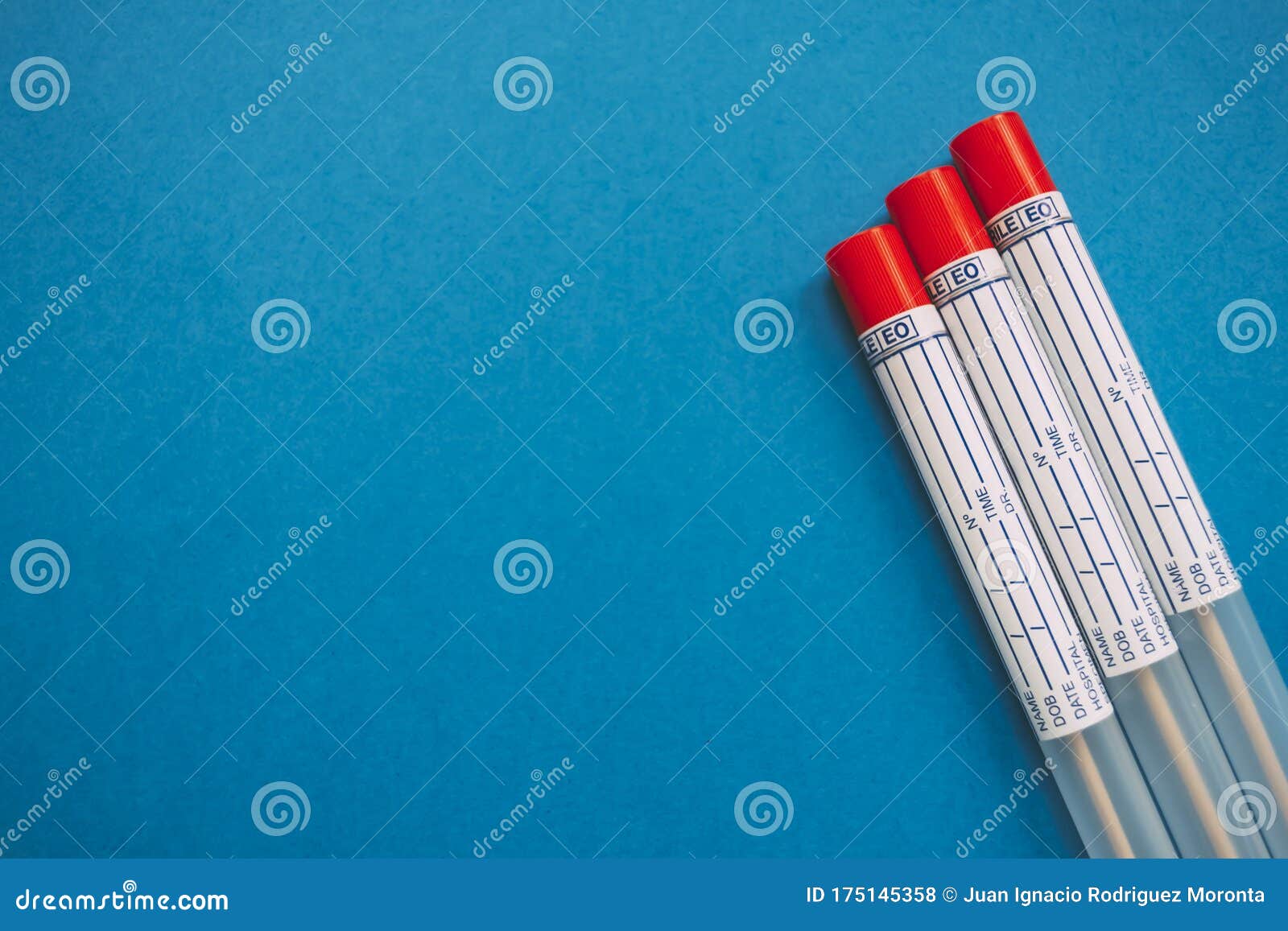 Three Laboratory Sample Tubes with Red Cap on Blue Background Stock ...
