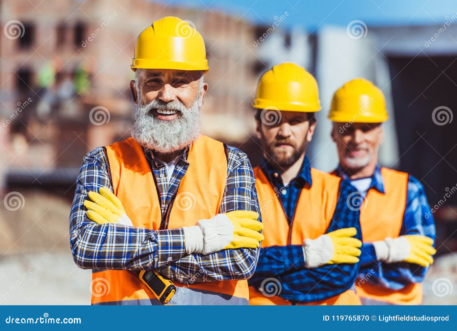 Three Labour Workers Posing with Arms Crossed at the Stock Photo ...