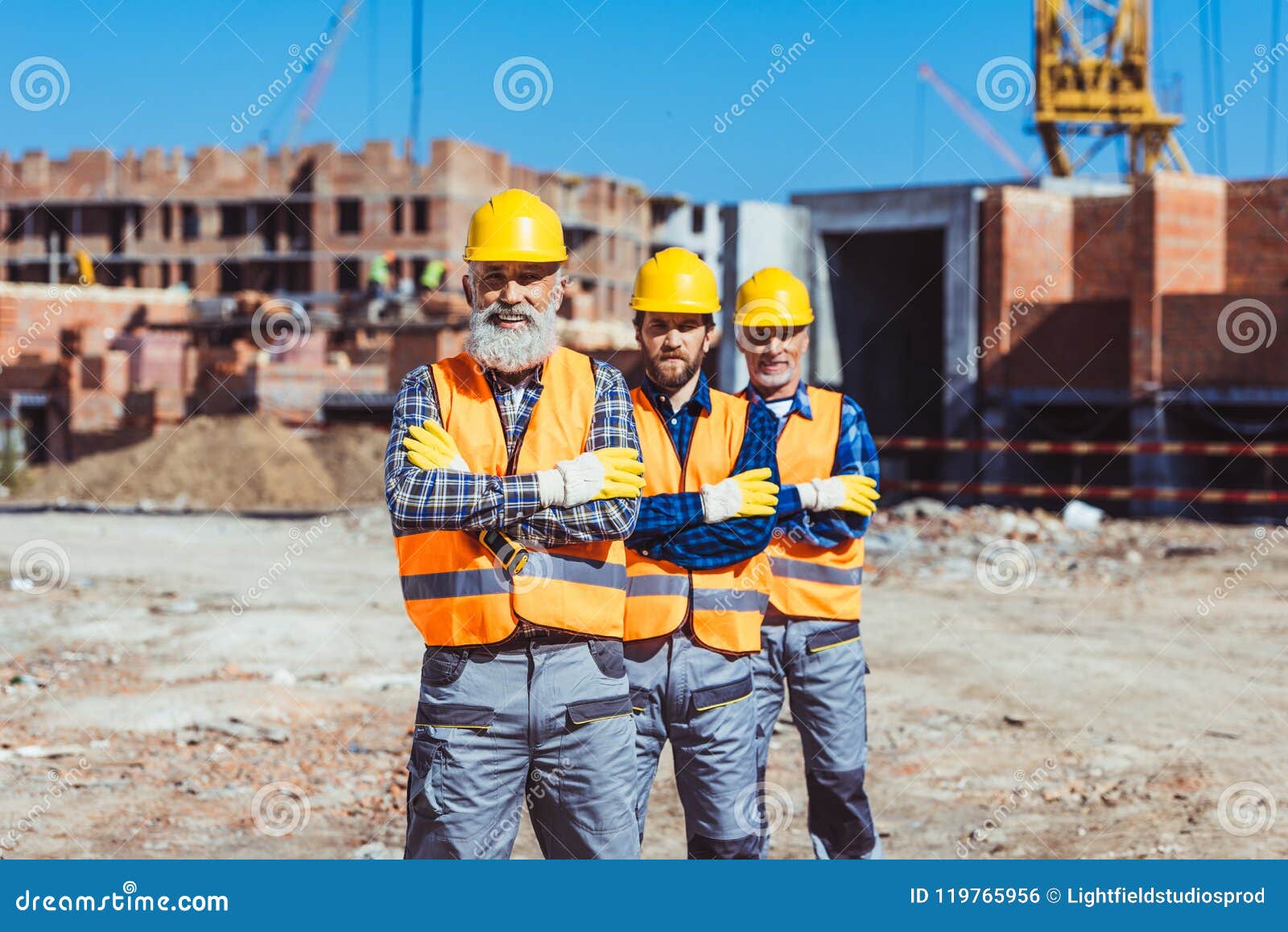 Three Labour Workers Posing with Arms Crossed at the Stock Photo ...