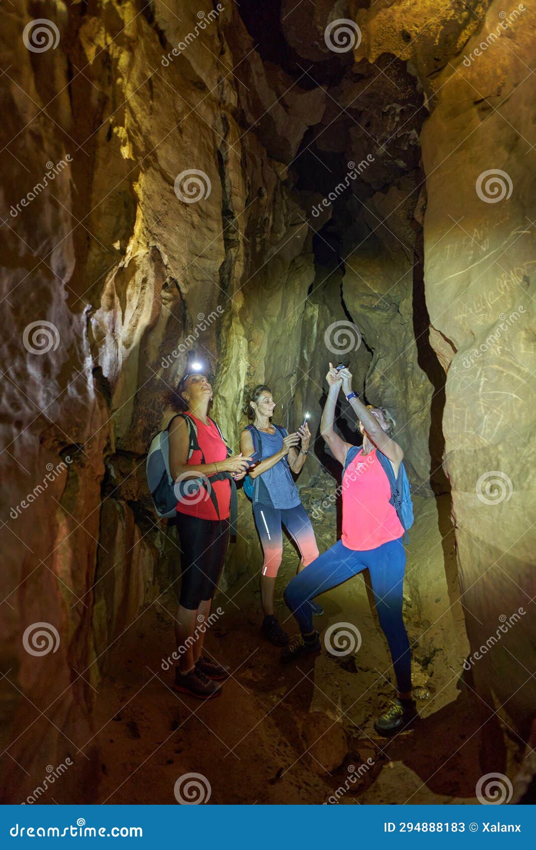 Three Ladies Exploring a Cave Stock Image - Image of boulders ...