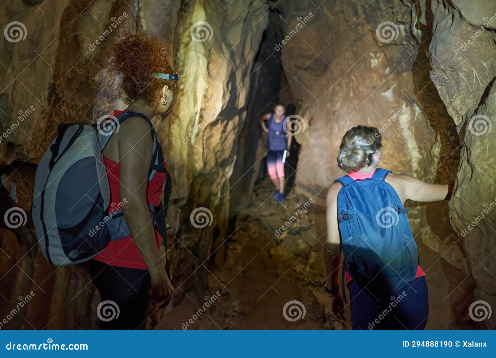 Three Ladies Exploring a Cave Stock Photo - Image of caving, dark: 294888190