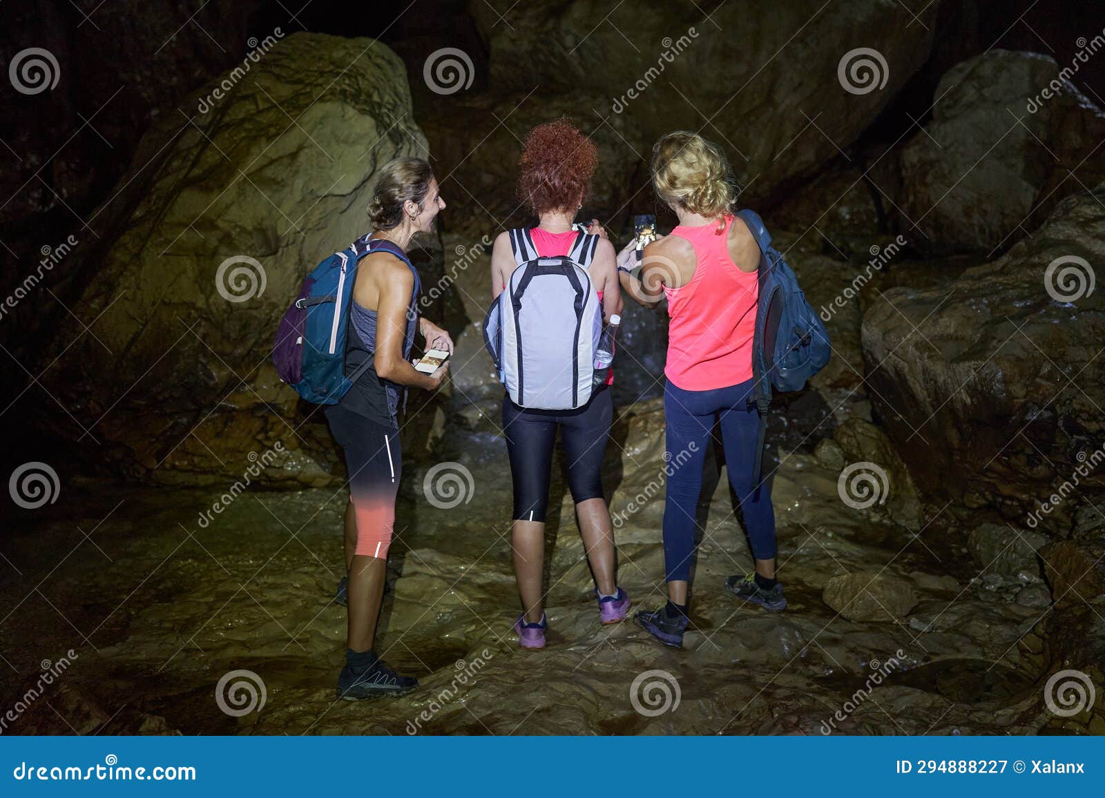 Three Ladies Exploring a Cave Stock Image - Image of geology, tunnel ...
