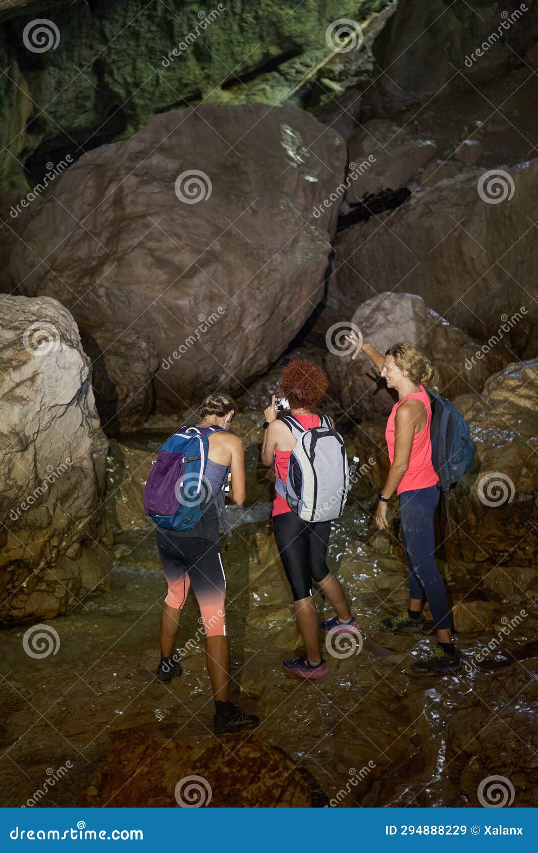 Three Ladies Exploring a Cave Stock Image - Image of group, geology ...