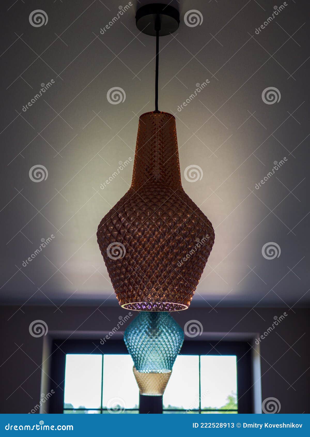 Three Lamps Hanging in a Row on the Ceiling with a Window in the ...