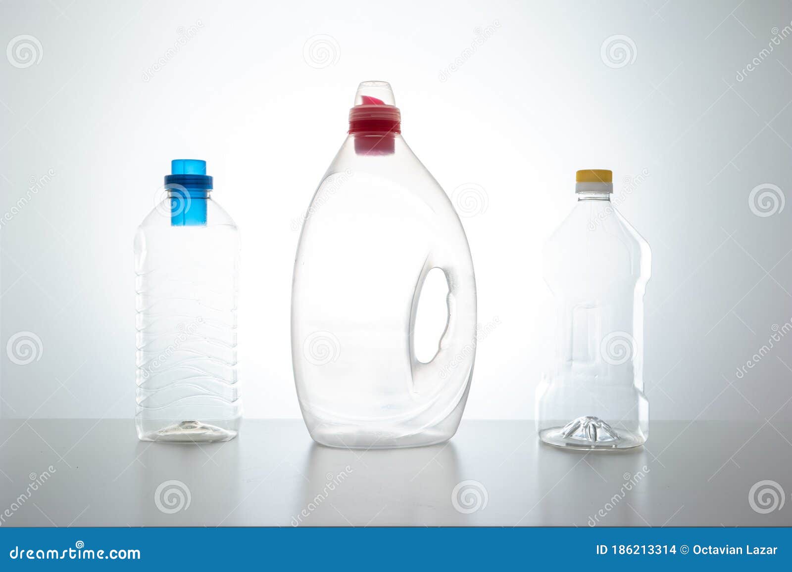 Three Large Empty Clear Plastic Bottles with No Labels and Different ...