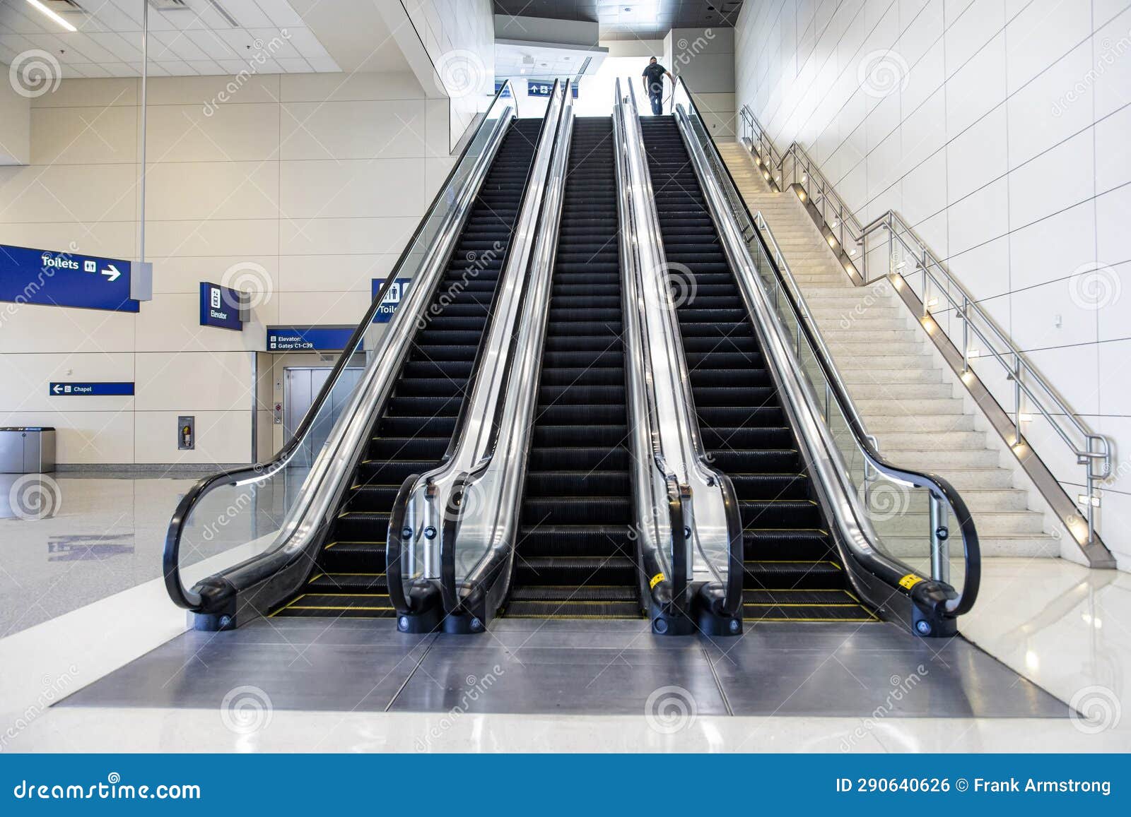 Three Large Escalators with One Man at the Top Stock Photo - Image of ...