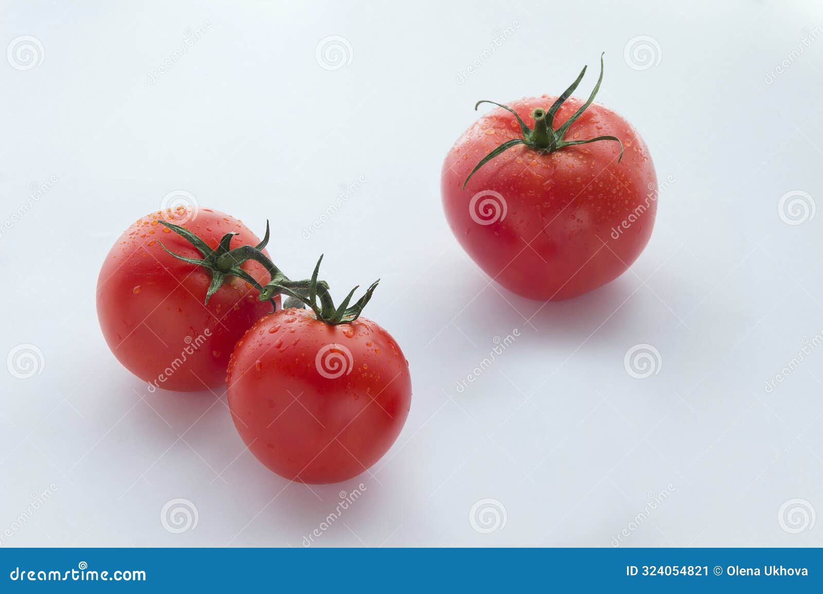 Three Large and One Small Tomato on a White Background Stock Image ...