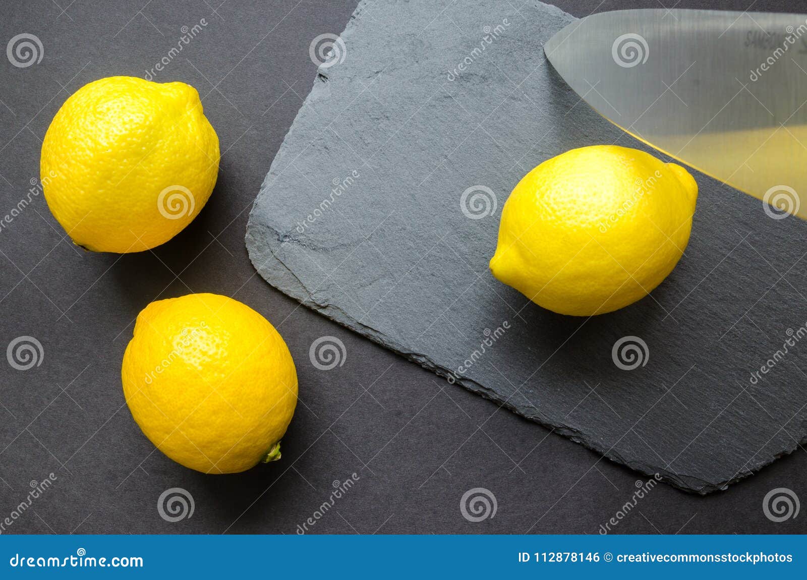 Three Lemons On Grey Surface Picture. Image: 112878146