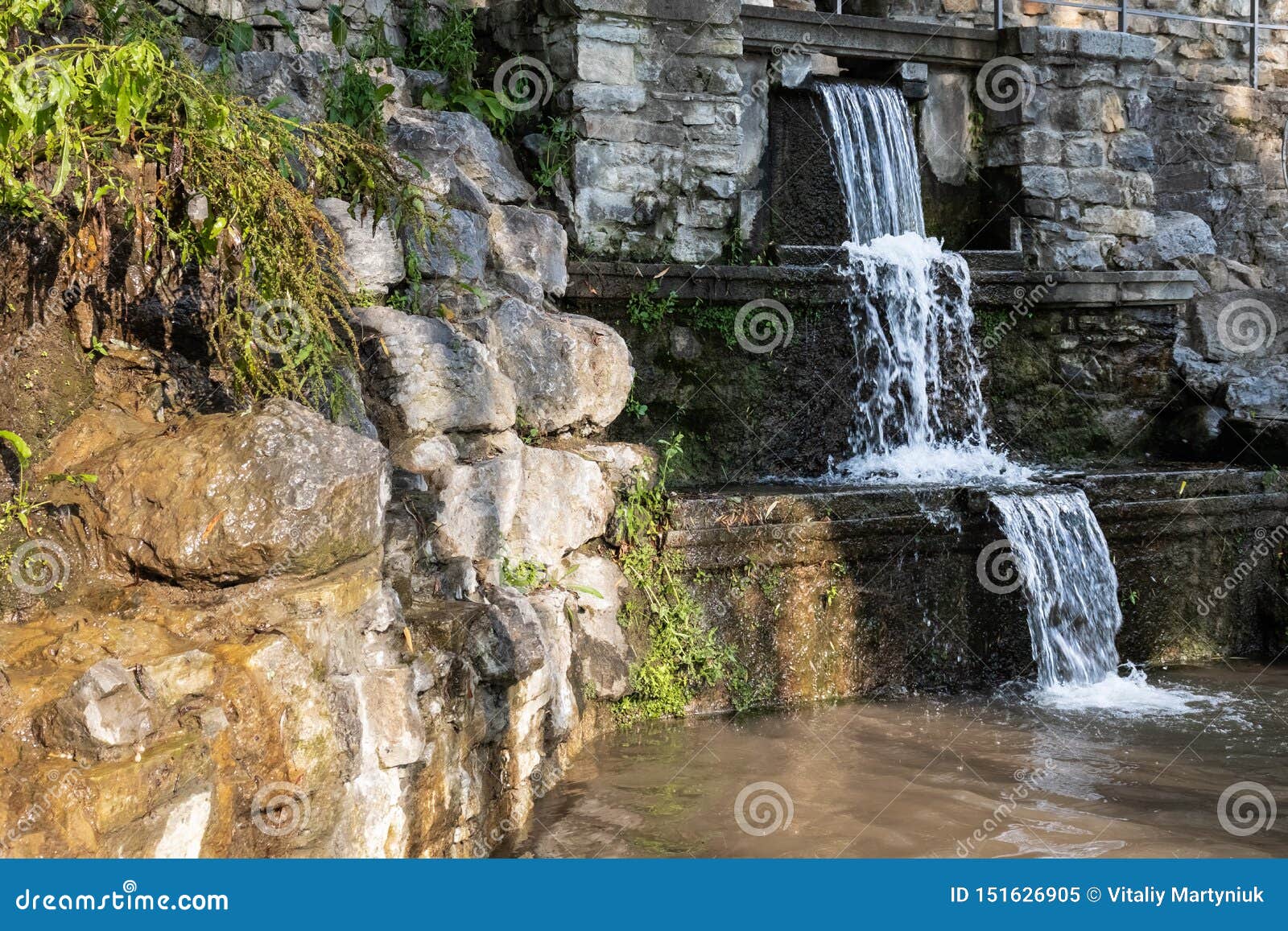 A Three-level Waterfall Flowing among the Stone Walls. Stock Image ...