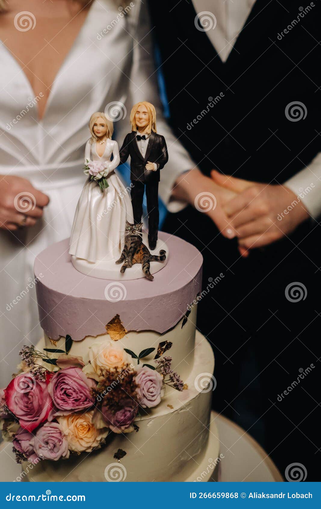 Three-level Wedding Cake with Figures of People on it Stock Photo ...