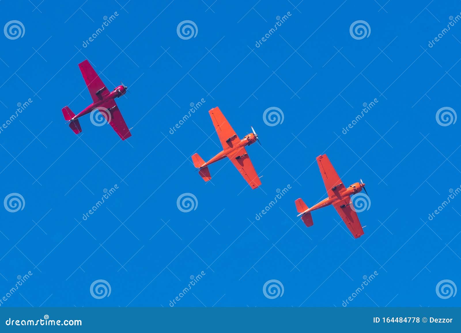 Three Light-engine Turboprop Red Aircraft Fly in Formation in a ...