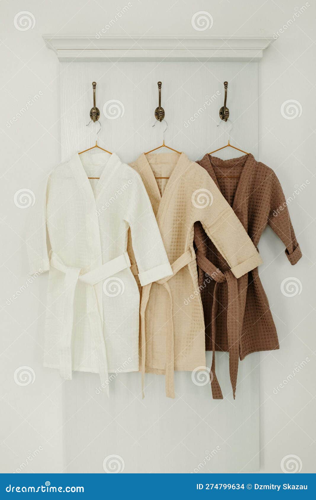 Three Linen Robes of Different Colors Hang on a Hanger in the Bathroom ...