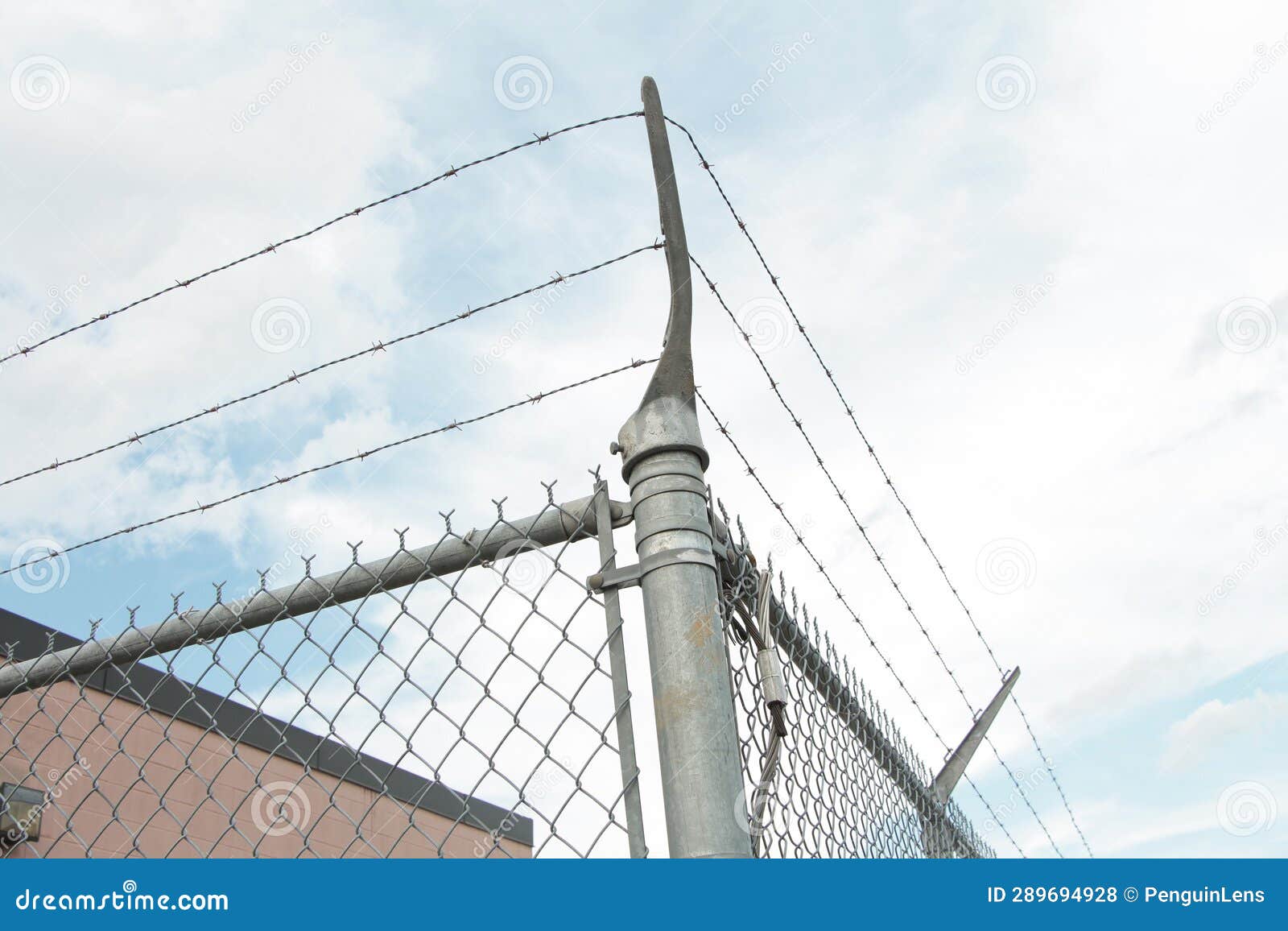 Three Lines of Barbed Wire at Top of Silver Fence Corner with Sky ...