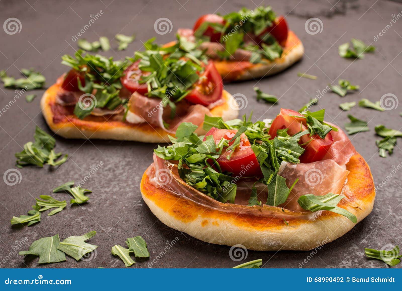 Three Little Pizza with Tomato, Rucola and Parma Ham Stock Photo ...