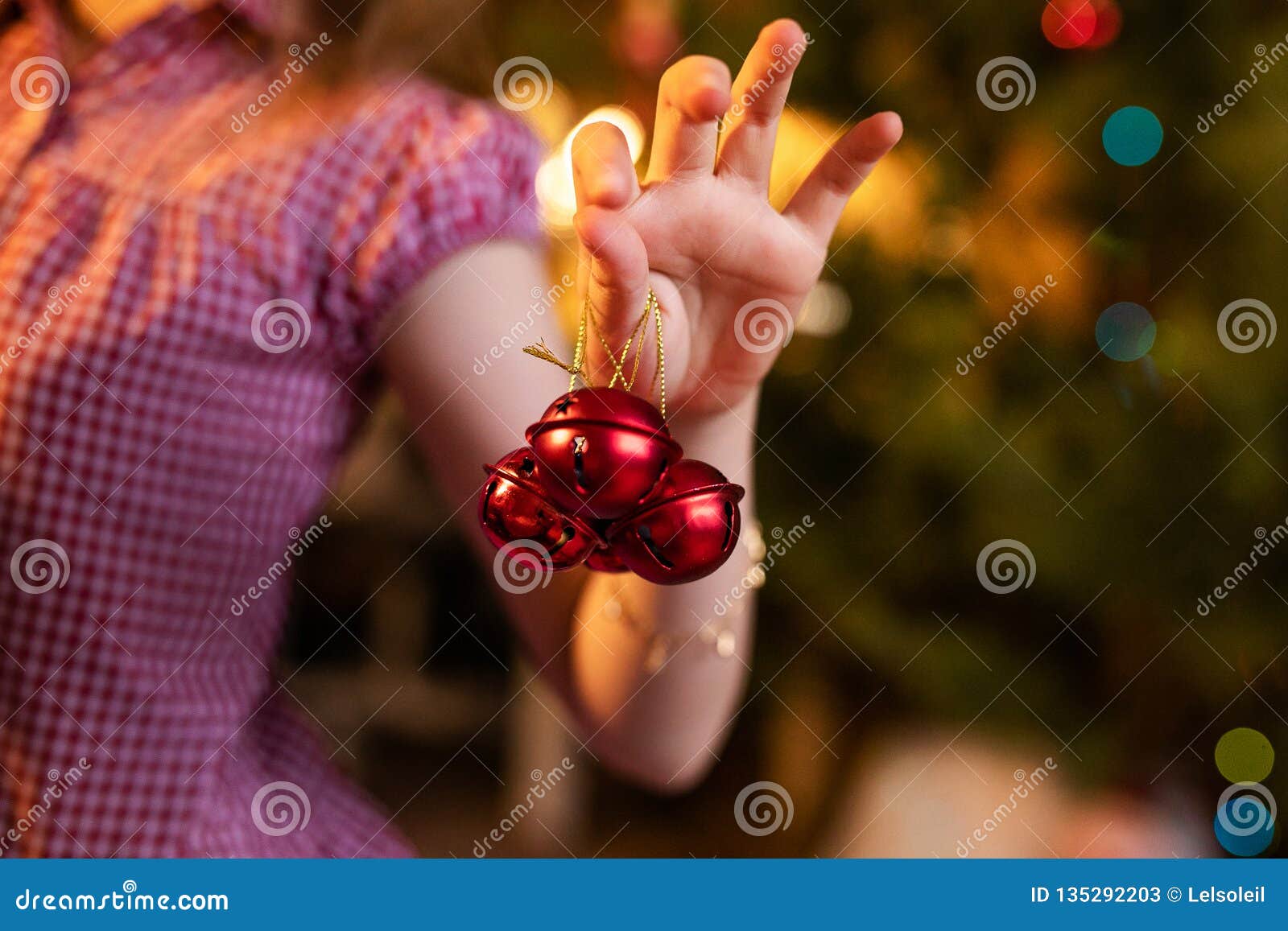 Three Little Red Jingle Bells in the Hand of Child Stock Image - Image ...