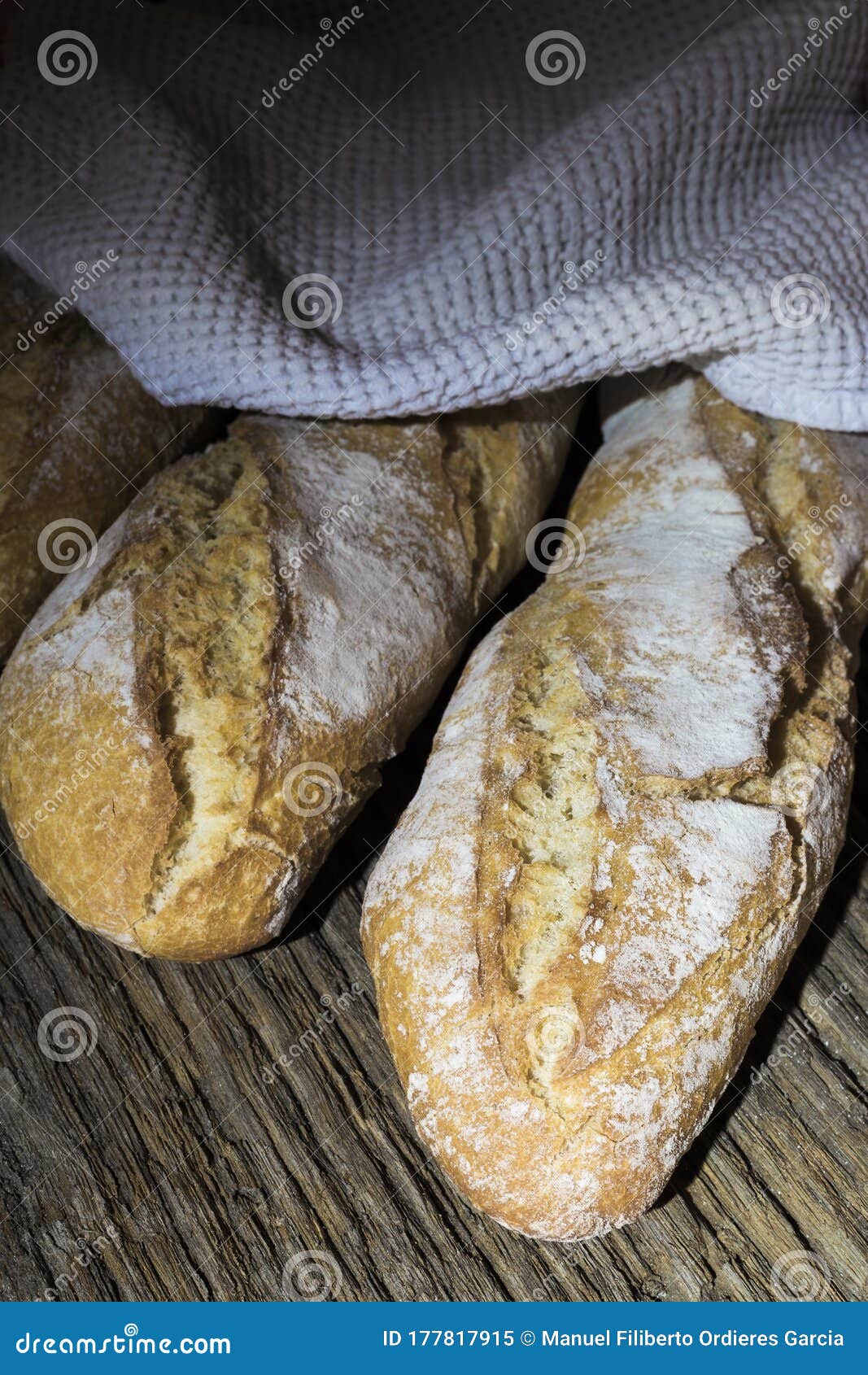 Three Loaves of Rustic Bread on a Wooden Board Stock Image - Image of ...