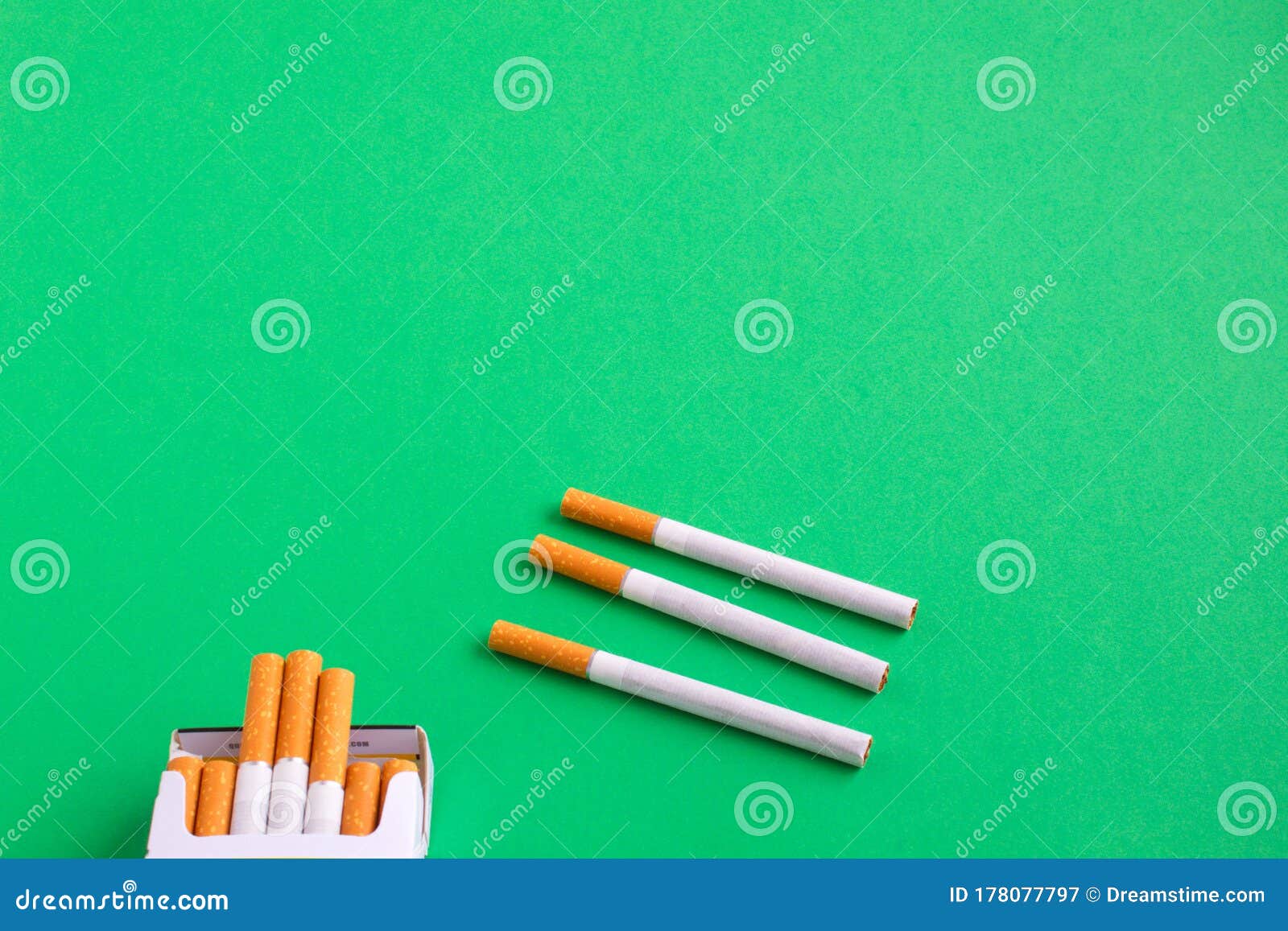 Three Loose Cigarettes Next To a Pack on the Green Table Stock Image ...