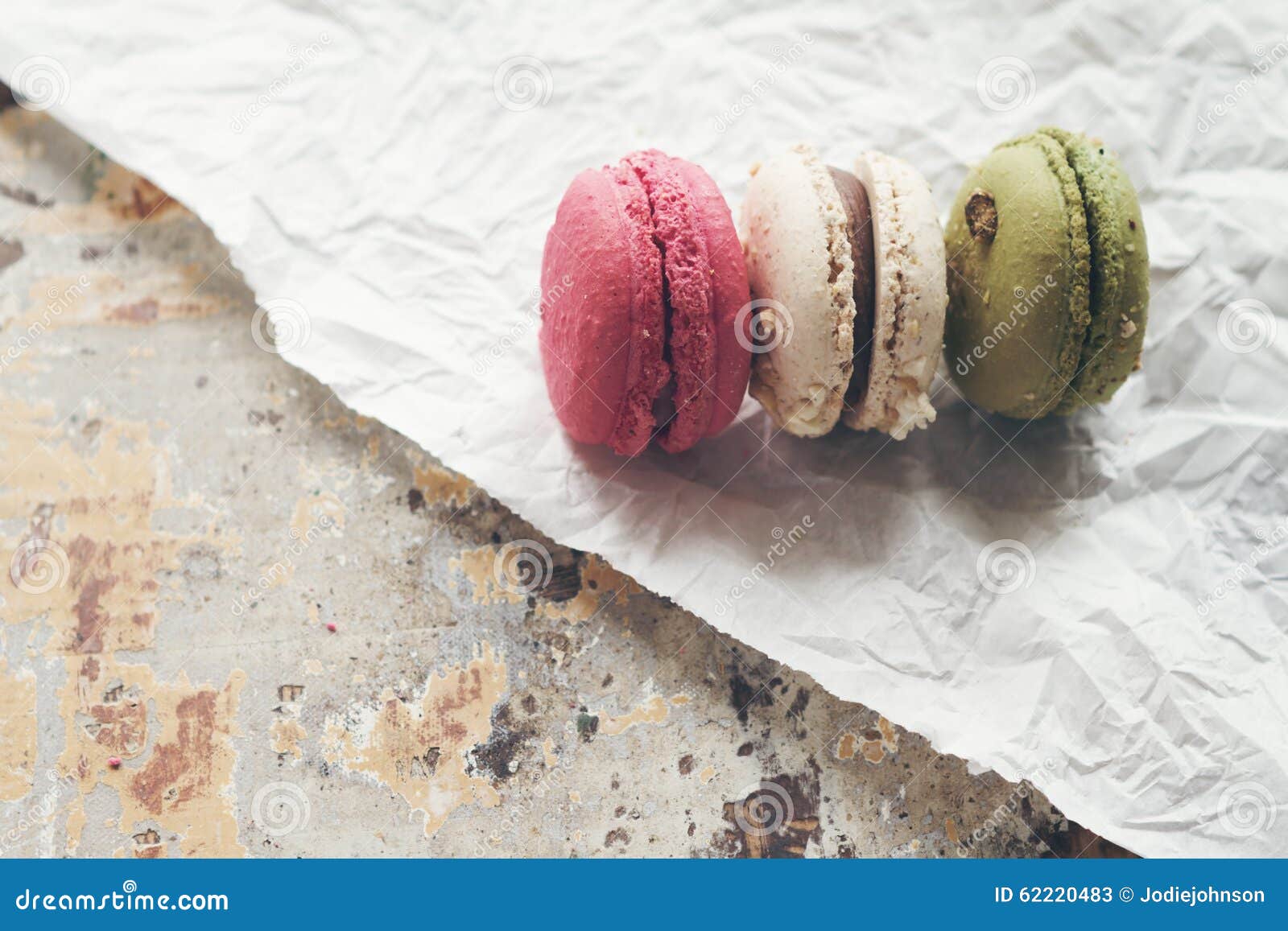 Three Macaroon Cakes on Crumpled Paper and Rustic Table Stock Image ...