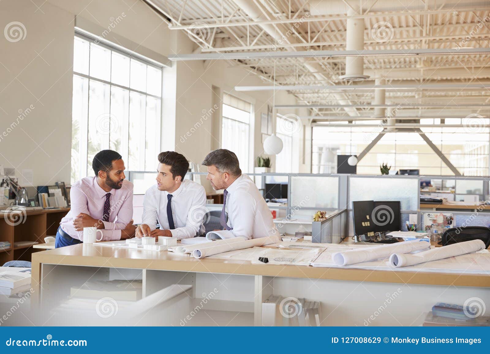 Three Male Architects in Discussion in an Open Plan Office Stock Image ...