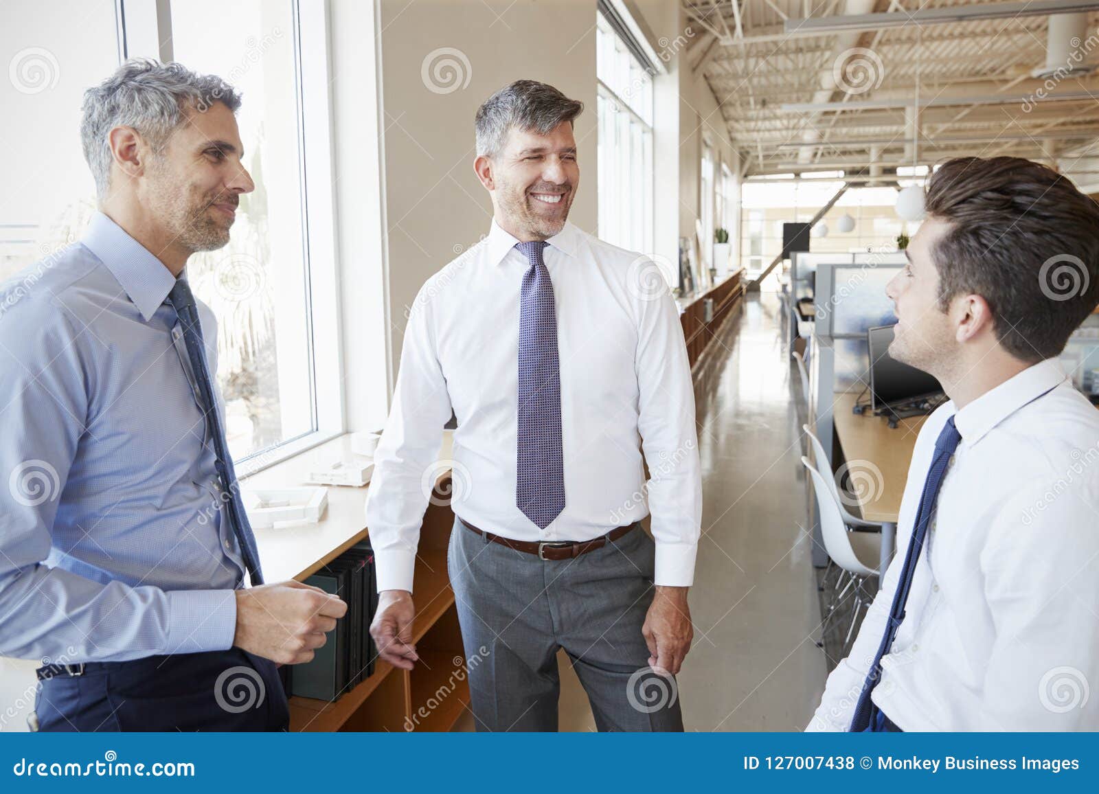 Three Male Business Colleagues Talking at Work, Close Up Stock Photo ...