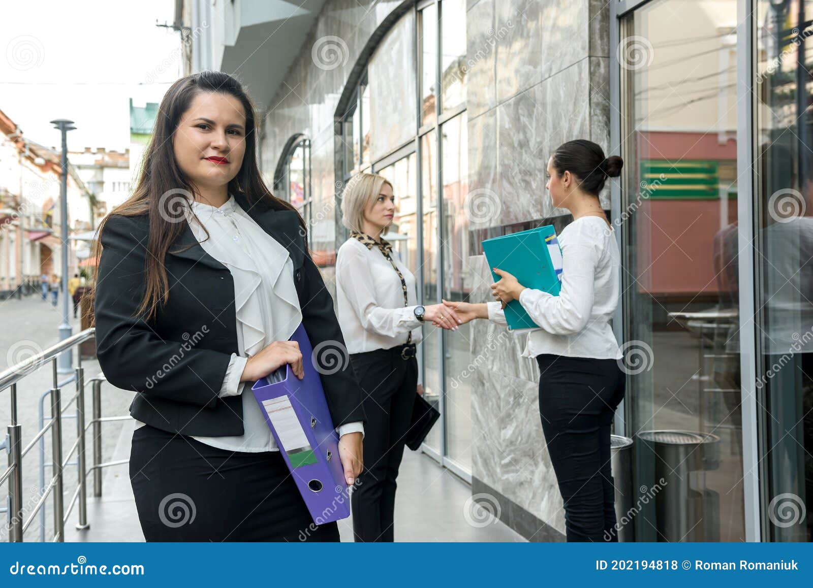 Three Managers with Folders Posing Outside Office Building Stock Photo ...