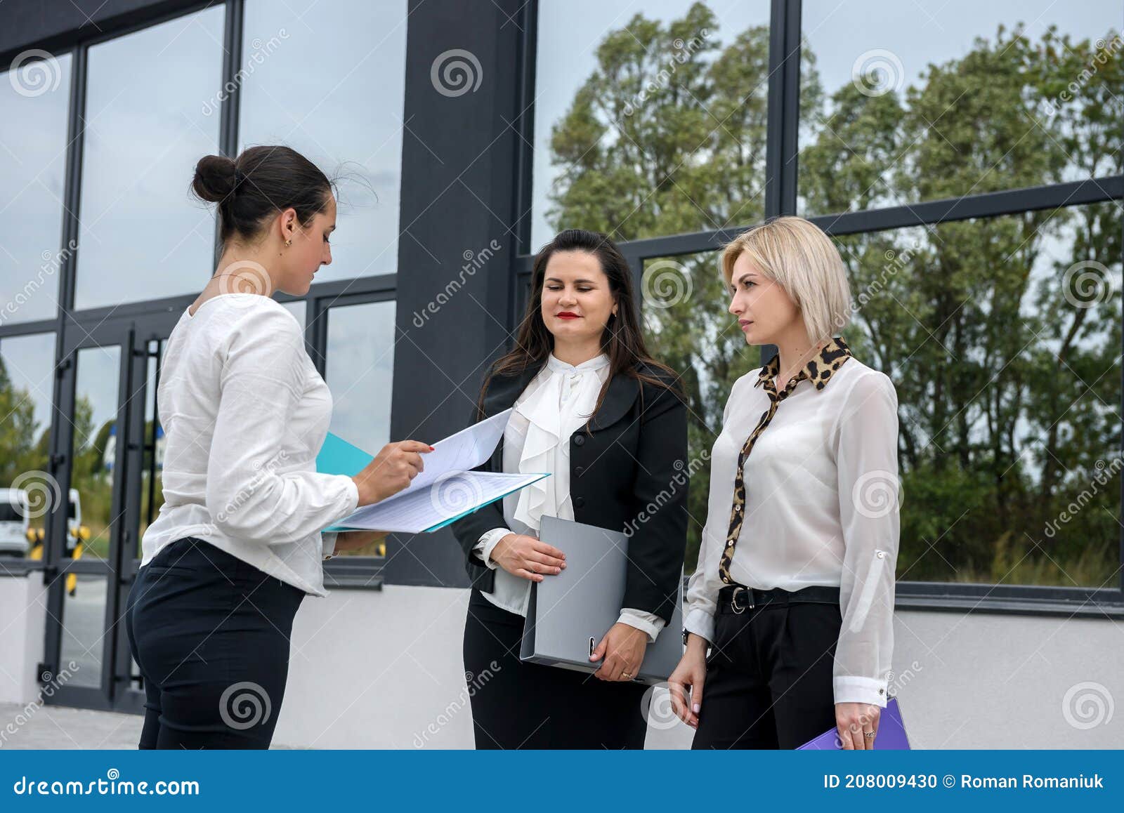 Three Managers with Folders Posing Outside Office Building Stock Photo ...