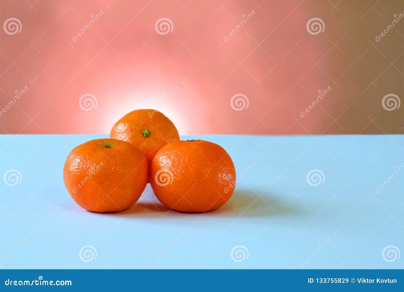 Three Mandarins on a Blue Table Stock Image - Image of group, juice ...