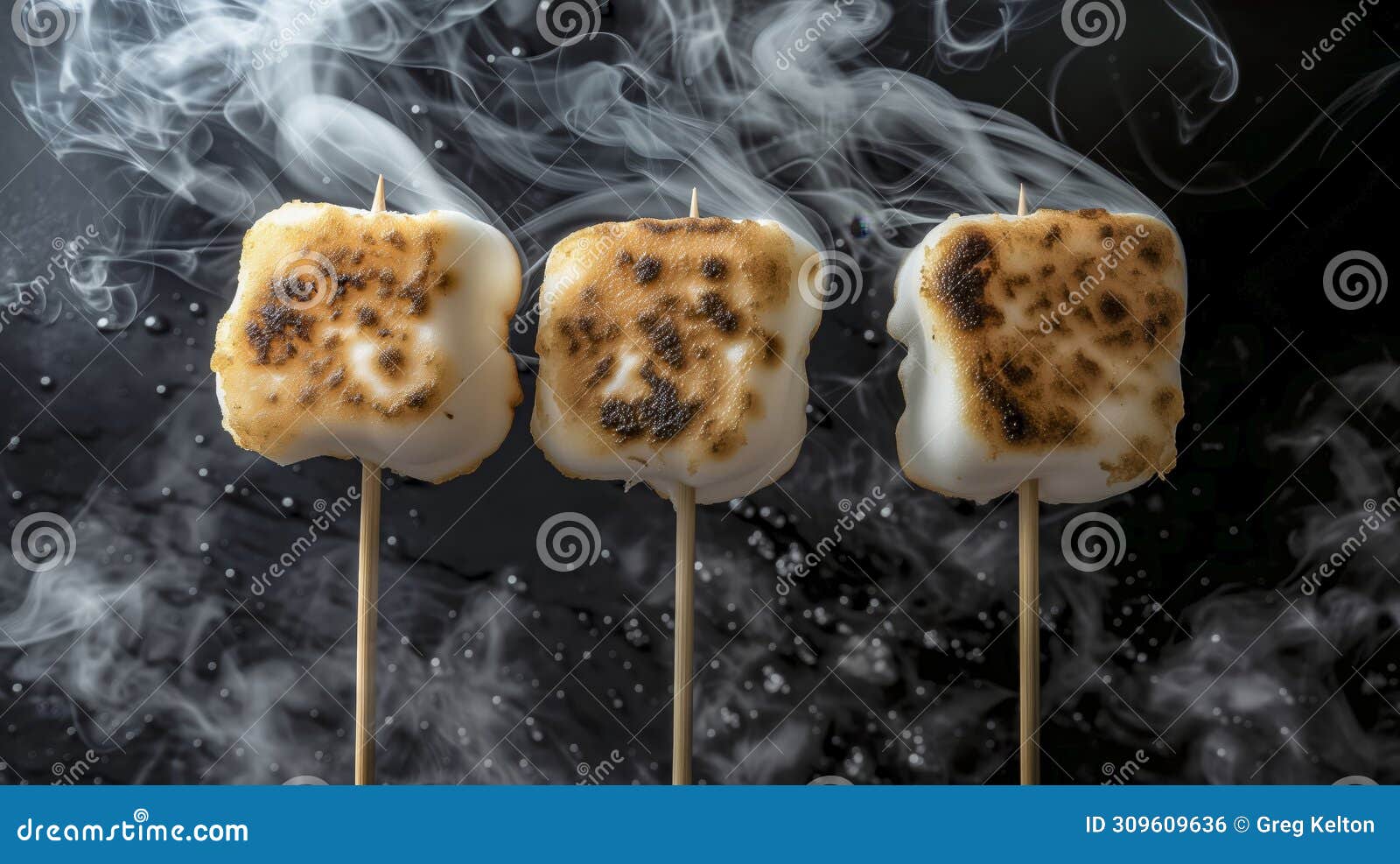 Three Marshmallows on Sticks with Flames and Smoke Rising As they are ...