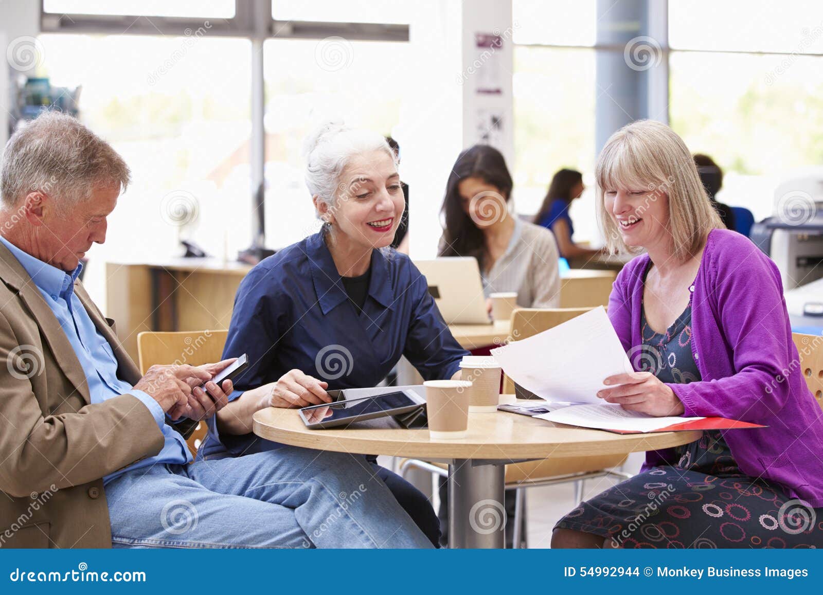 Three Mature Students Collaborating on Project Together Stock Photo ...